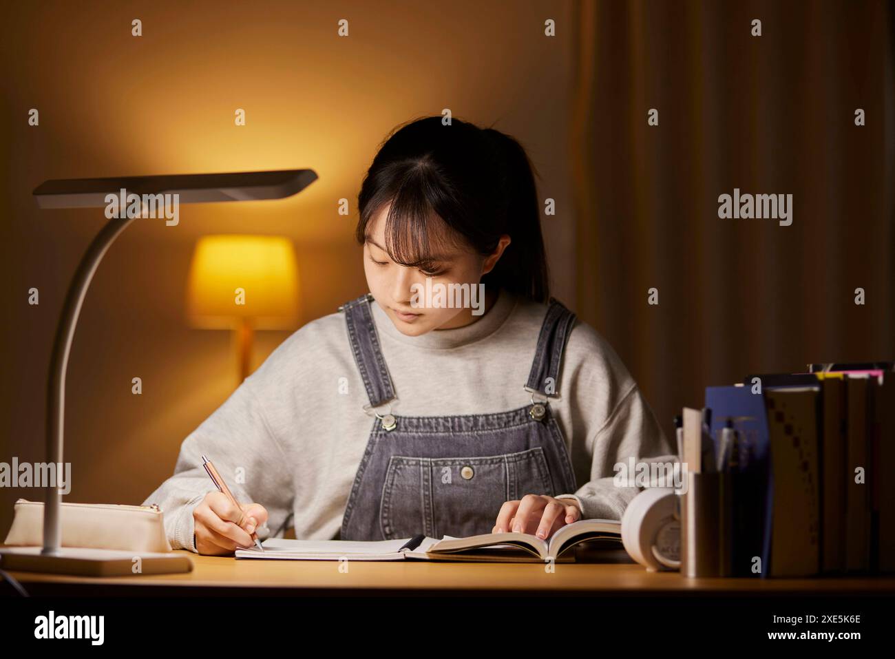 High school girl studying for an exam in her room Stock Photo - Alamy