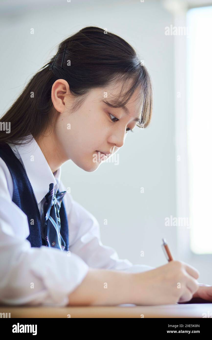 Female high school student taking a class in a school classroom Stock ...