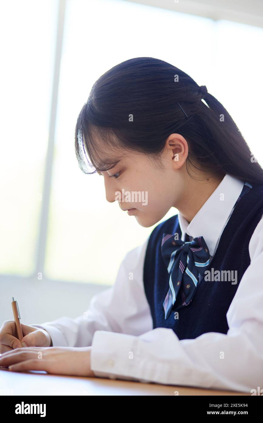 Female high school student taking a class in a school classroom Stock ...