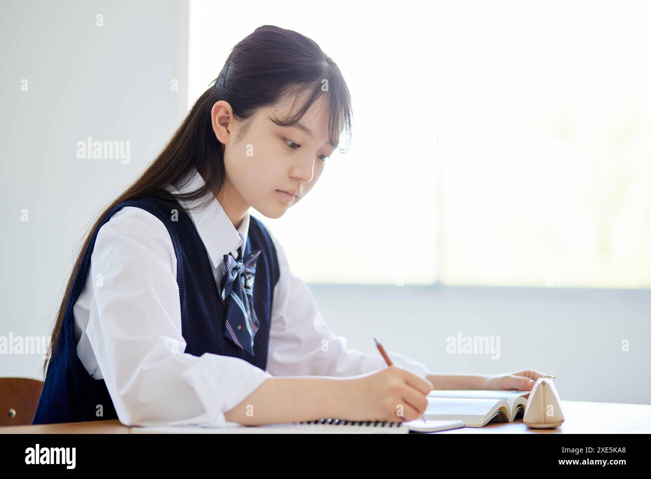 Female high school student taking a class in a school classroom Stock ...
