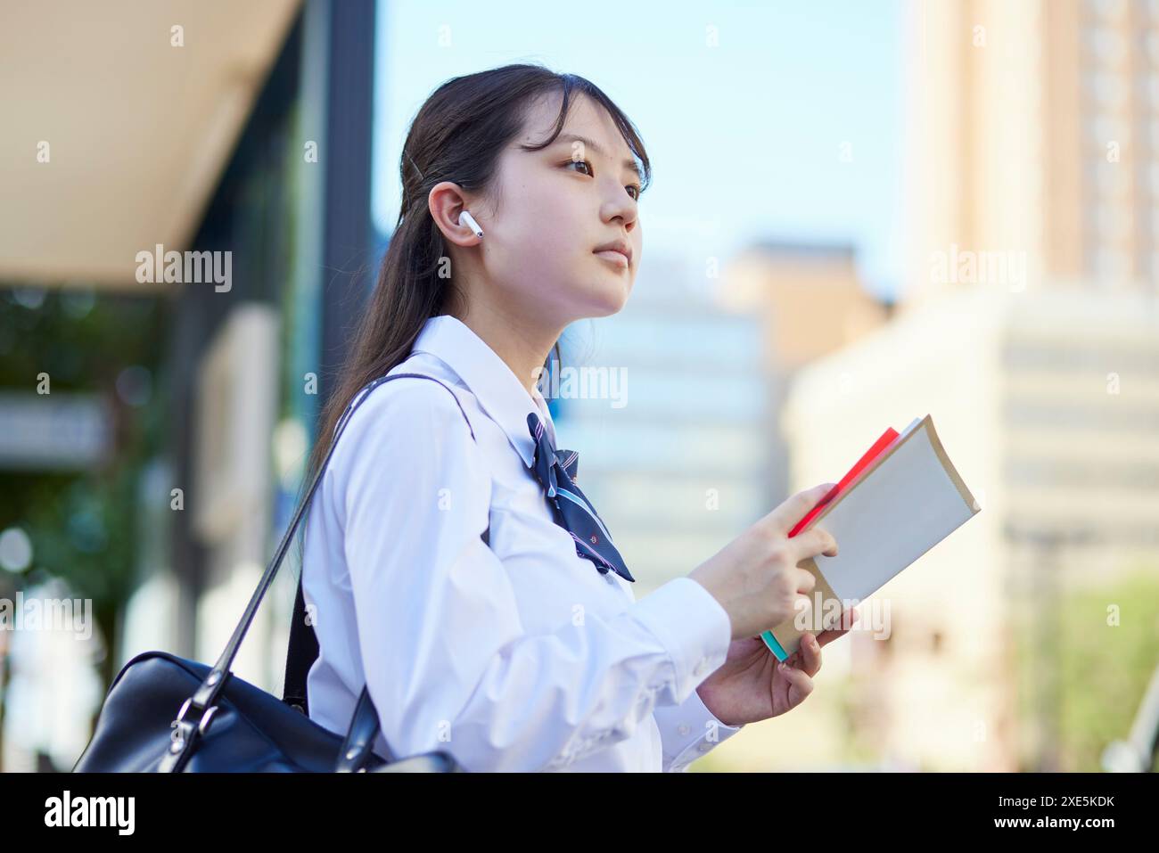 High school girl studying with reference book Stock Photo - Alamy
