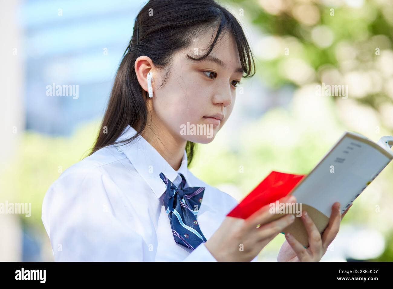 High school girl studying with reference book Stock Photo - Alamy