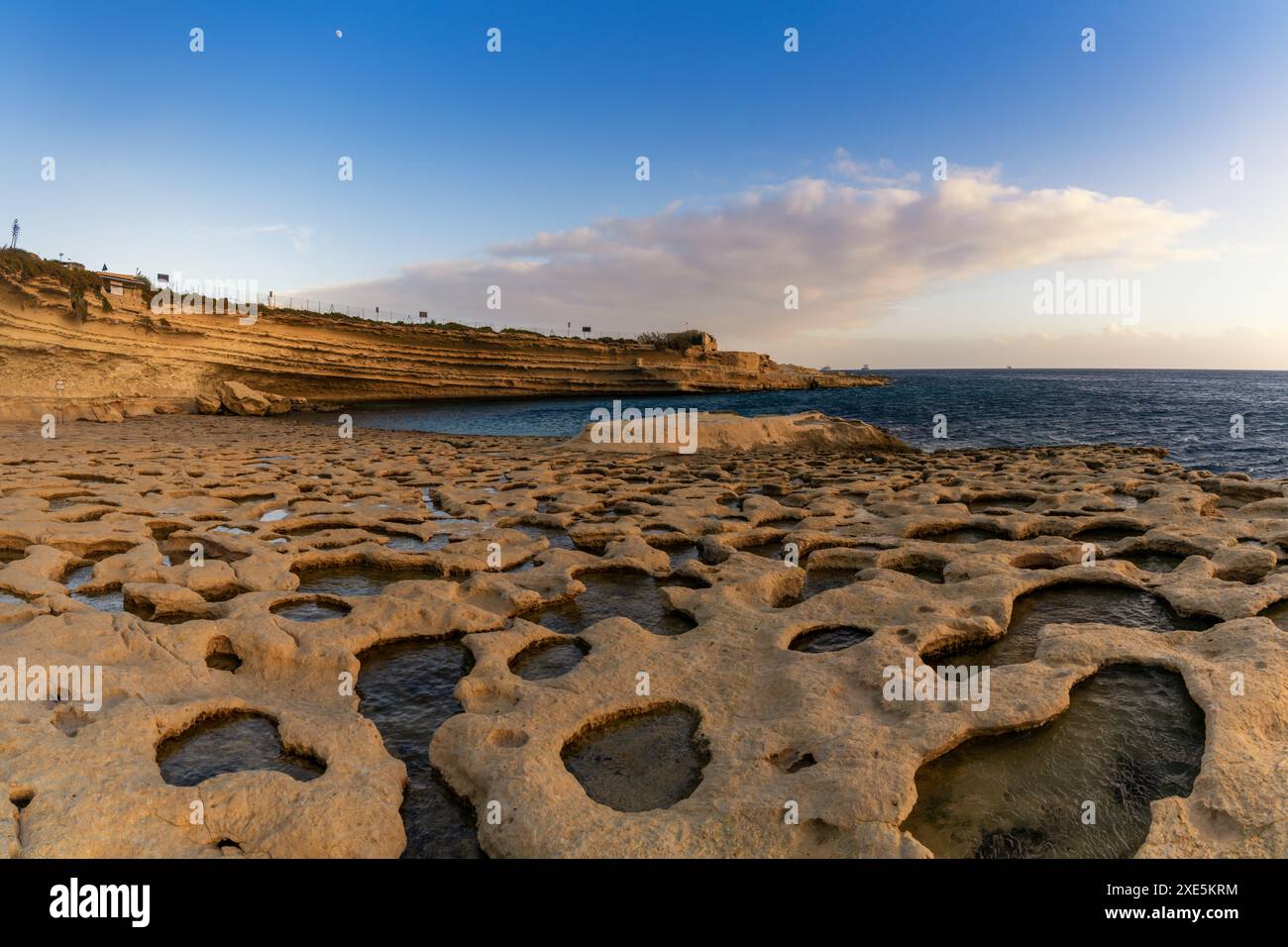 View of the tidal pools and cliffs at Il-Hofra z-Zghira Bay in Malta ...
