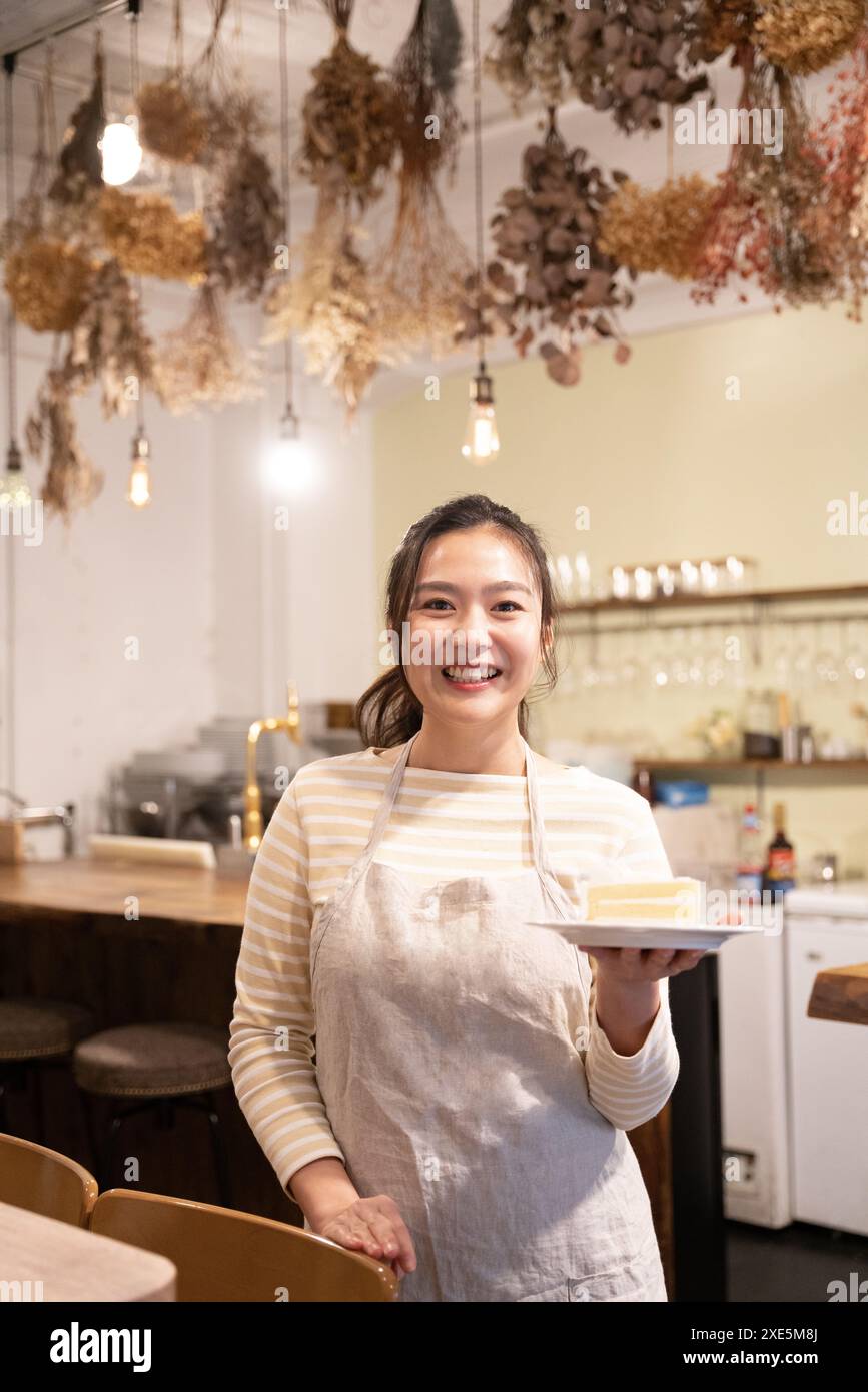 Female waitress working in café Stock Photo - Alamy
