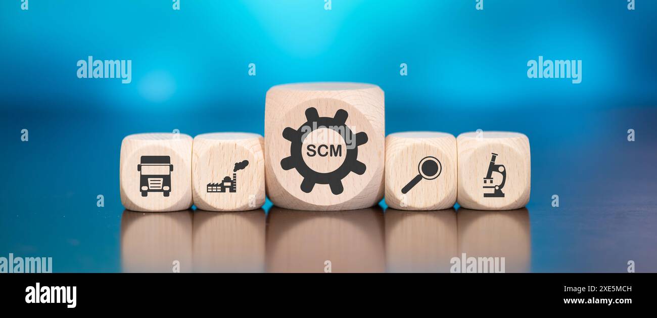 Wooden blocks with symbol of scm concept on blue background Stock Photo ...