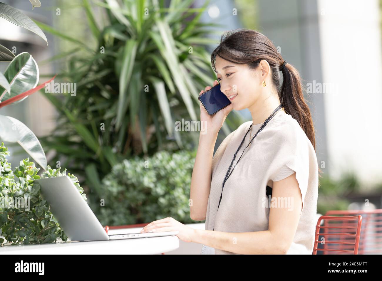 Woman operating smartphone outside hi-res stock photography and images ...