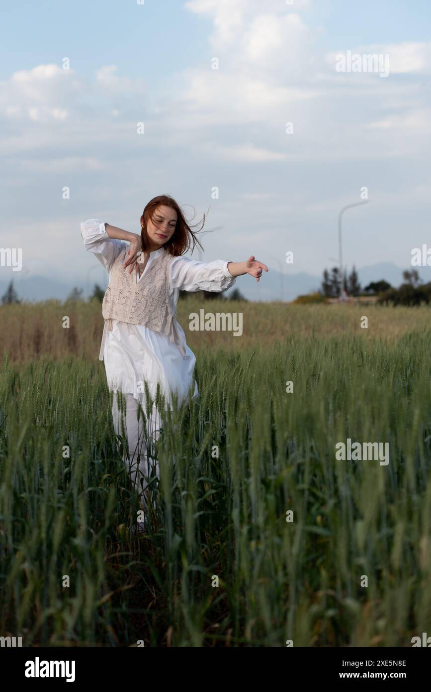 Young woman dancing outdoors. Modern dance performance in the meadow ...