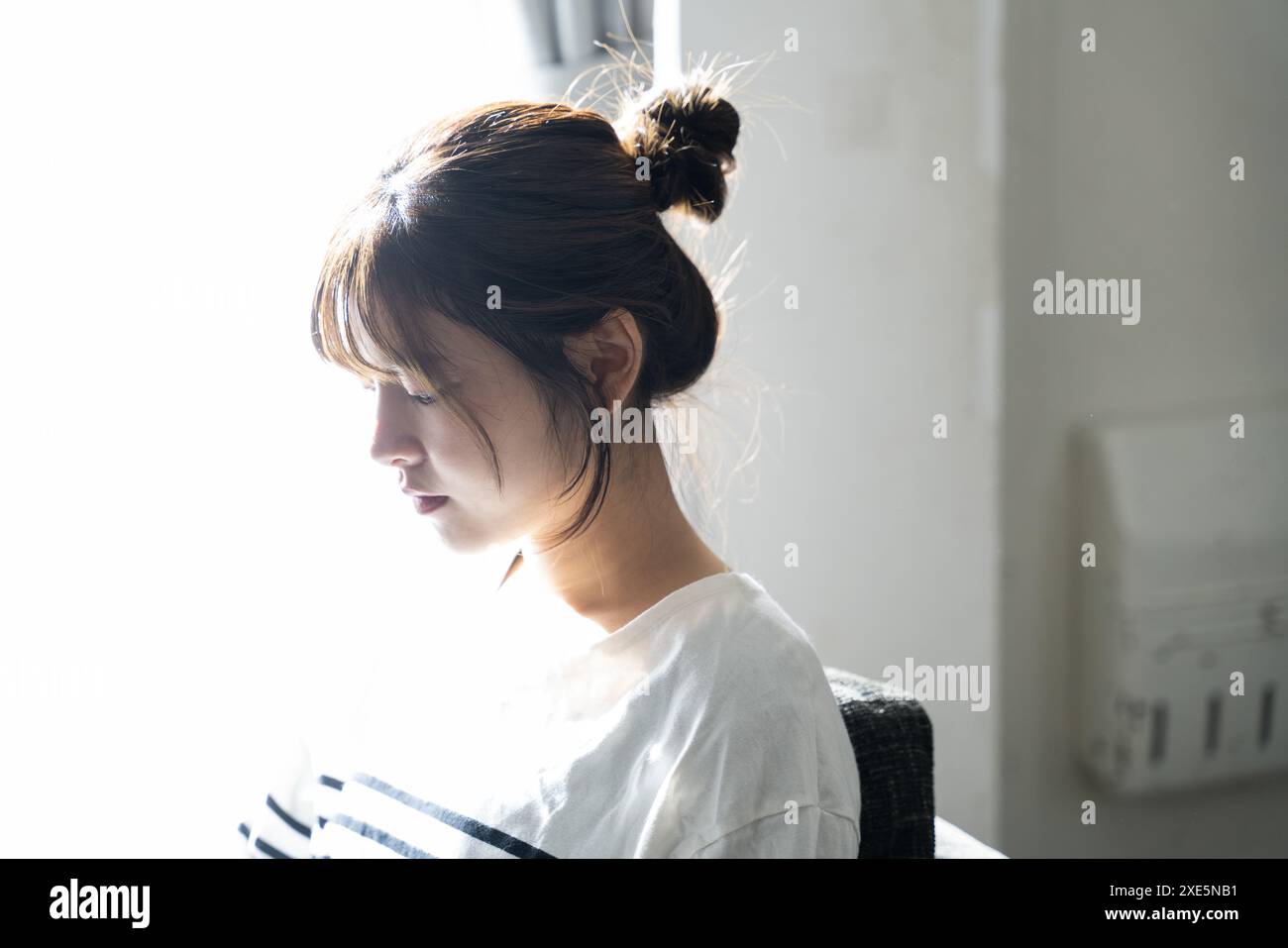 Side profile of a woman by a window Stock Photo - Alamy