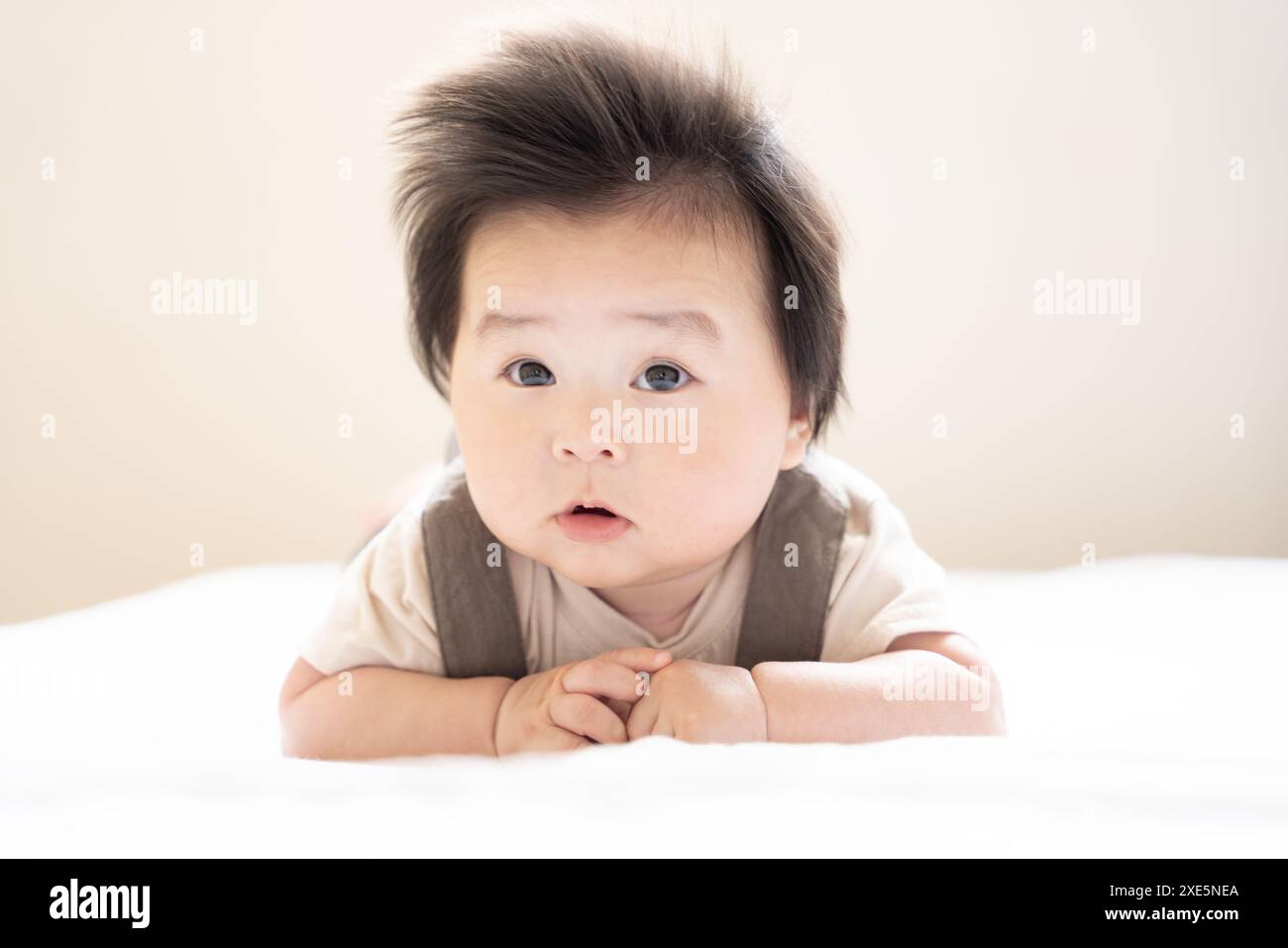Baby lying on belly, face up Stock Photo - Alamy