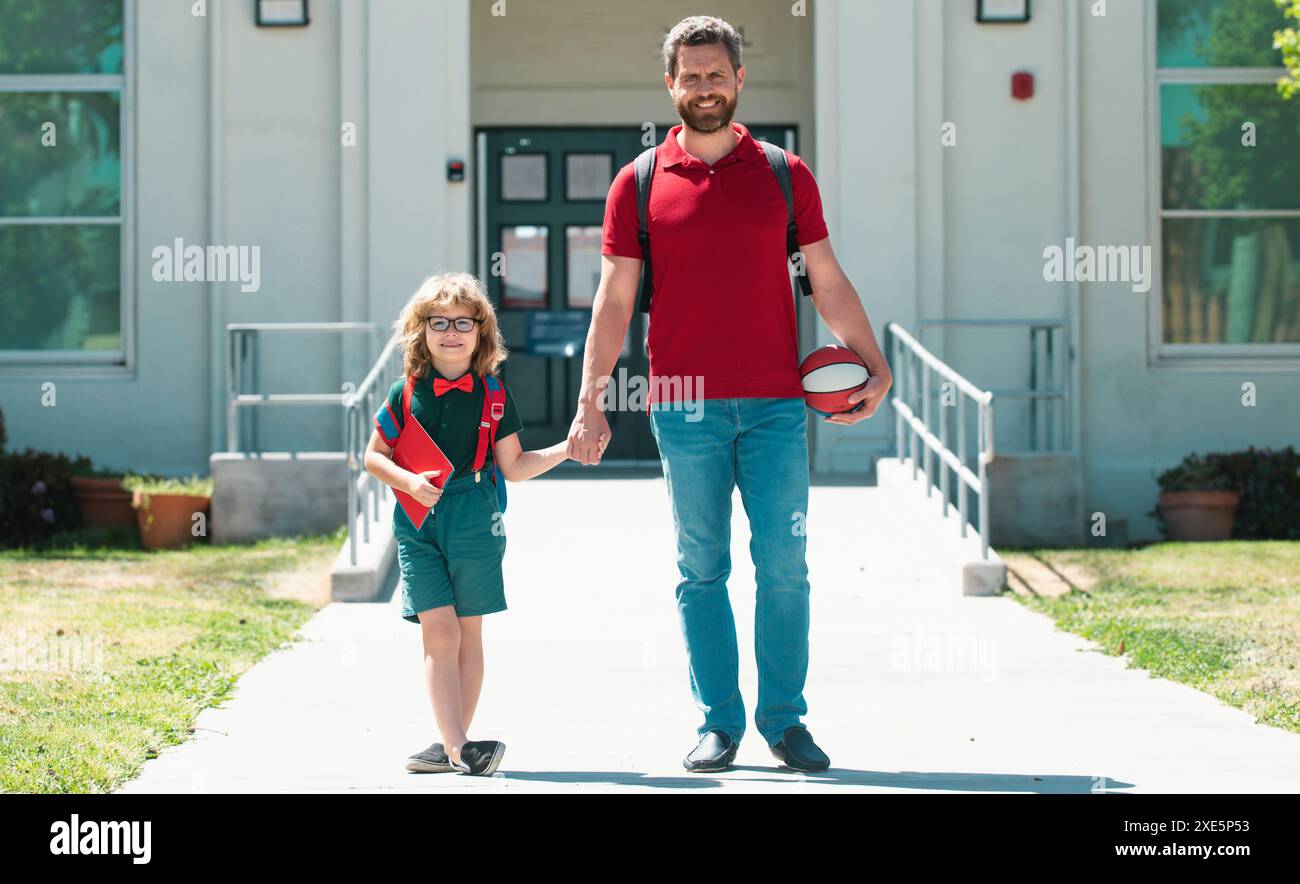Father walking son to school. Parent and pupil of primary school ...