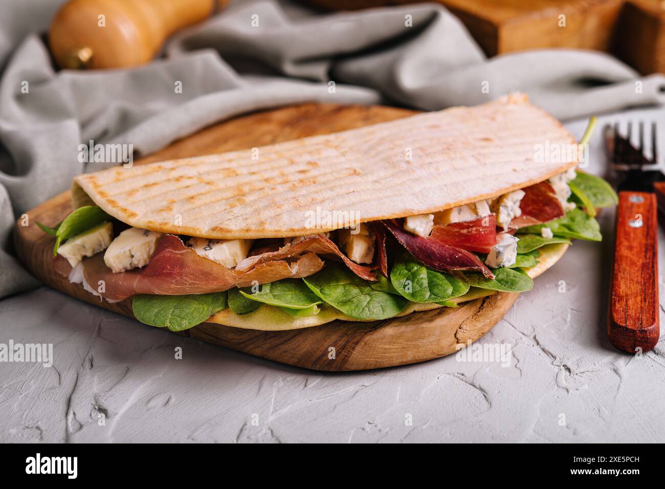 Piadina - classic Italian tortilla-bread with prosciutto, basil and dor ...