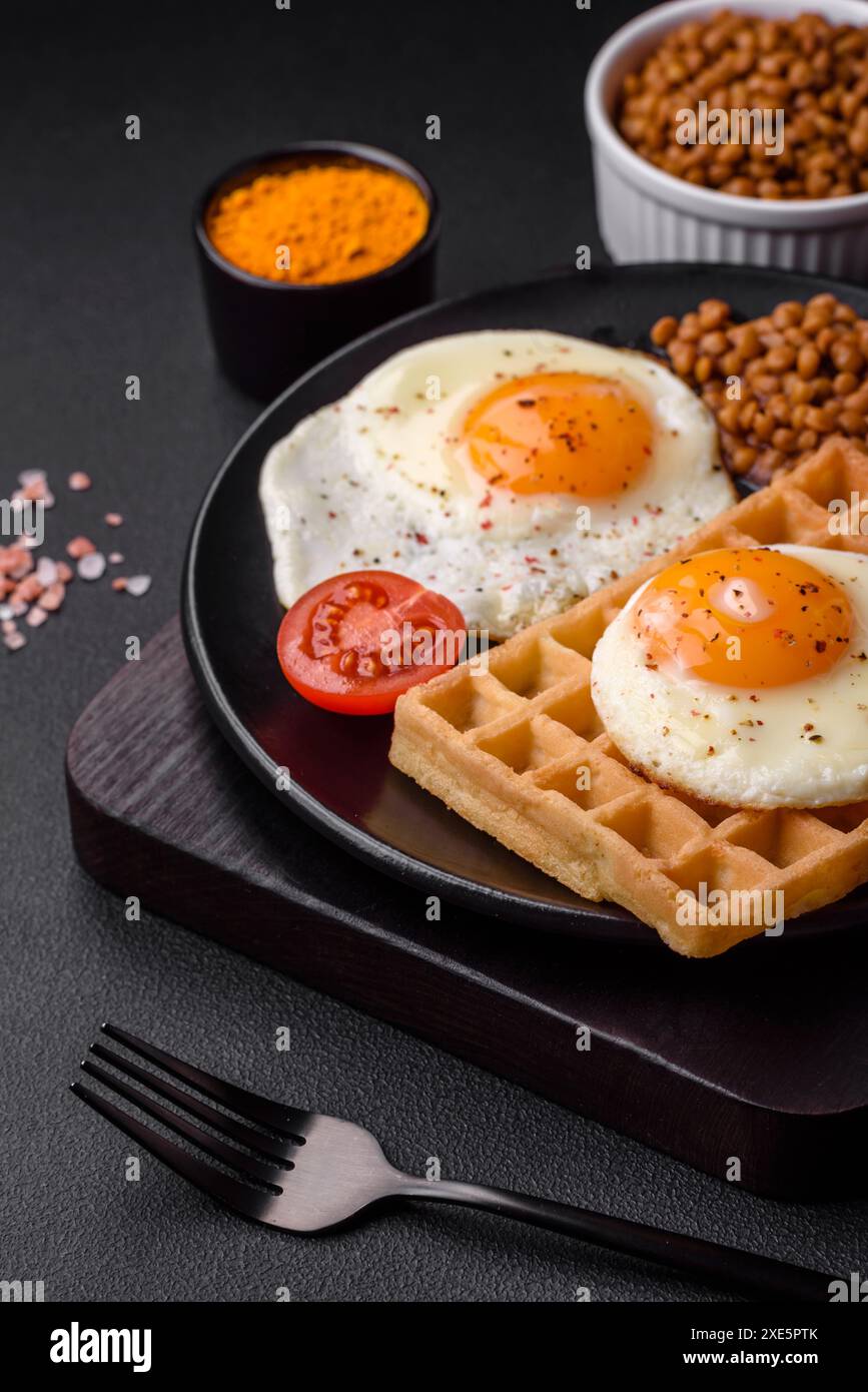 Delicious hearty breakfast consisting of a fried egg, Belgian waffle ...