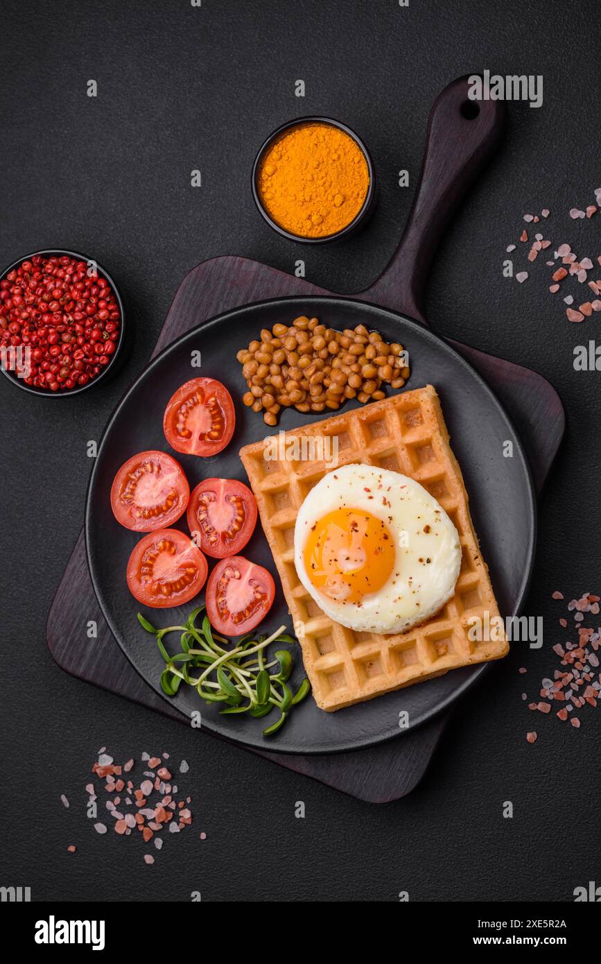 Delicious hearty breakfast consisting of a fried egg, Belgian waffle ...