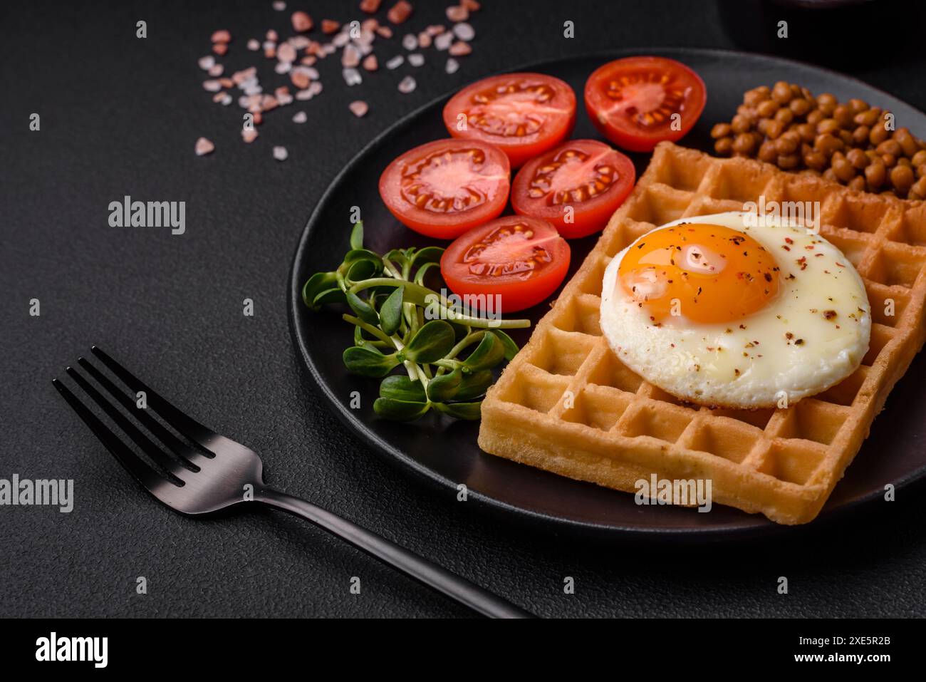 Delicious hearty breakfast consisting of a fried egg, Belgian waffle ...