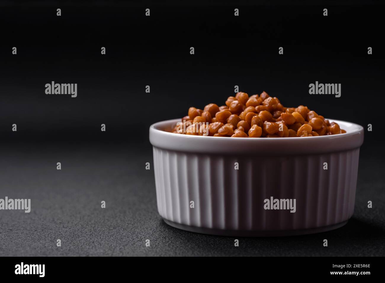 Delicious healthy canned lentils in a ceramic ribbed white bowl Stock ...