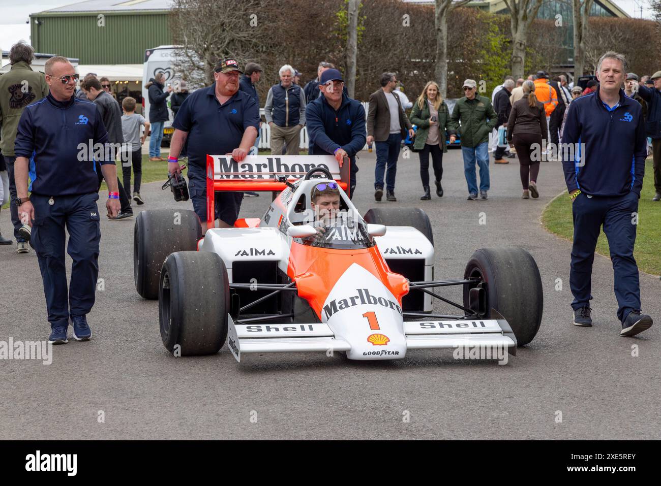 Niki Lauda's 1985 McLaren MP4/2B rolls through the paddock to the ...