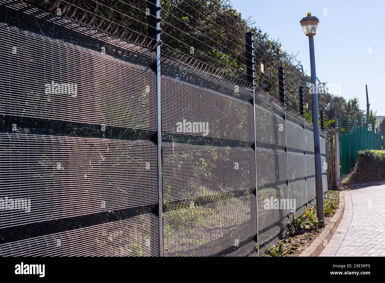 Security electrified fencing black and green structures on property ...