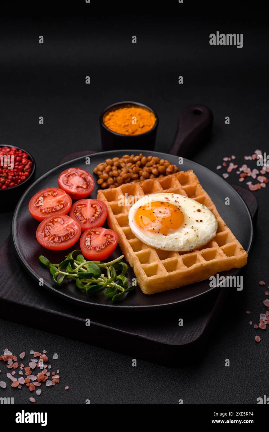 Delicious hearty breakfast consisting of a fried egg, Belgian waffle ...