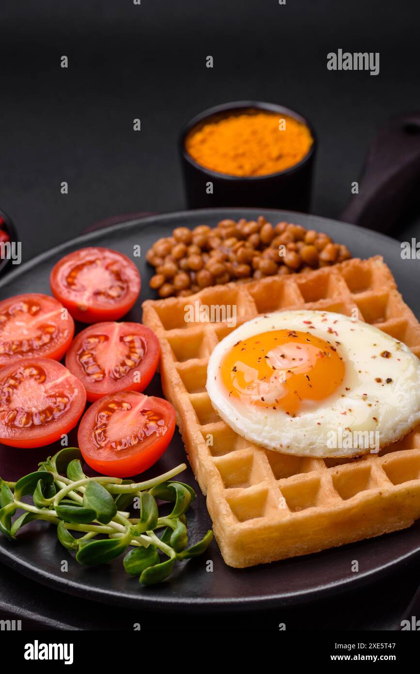 Delicious hearty breakfast consisting of a fried egg, Belgian waffle ...