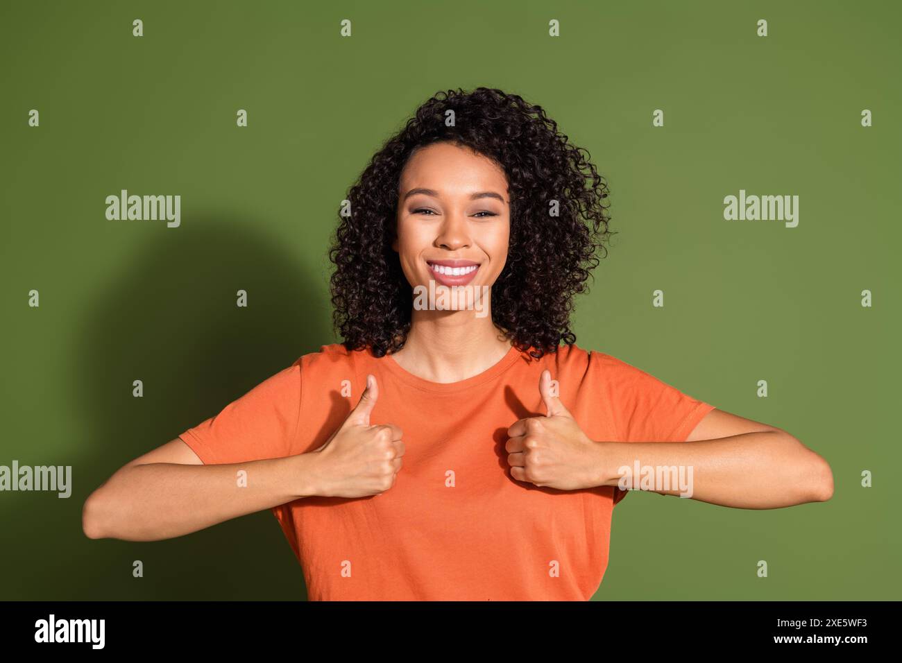 Photo portrait of lovely young lady thumb up dressed stylish orange ...