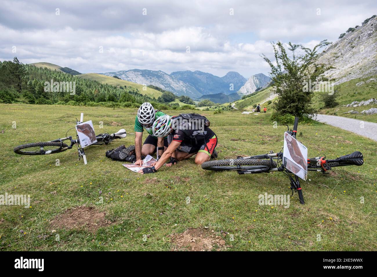 cyclists consulting a map, route to mount Amboto, Alava, basque country ...