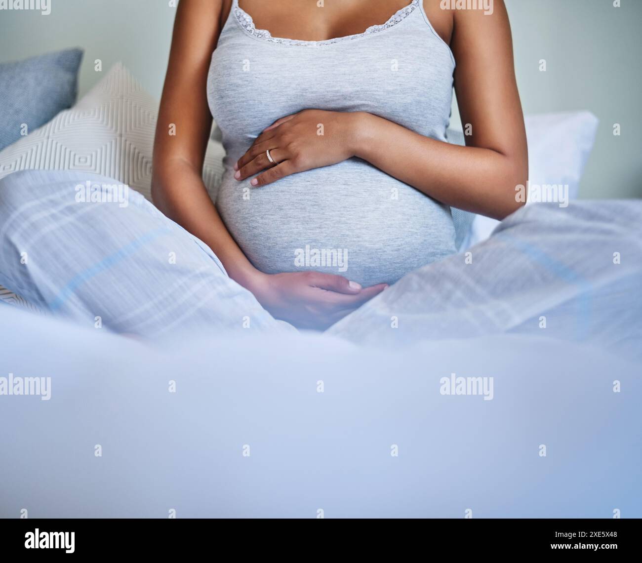 Woman, pregnant and hands on stomach for relax on bed, bonding and ...