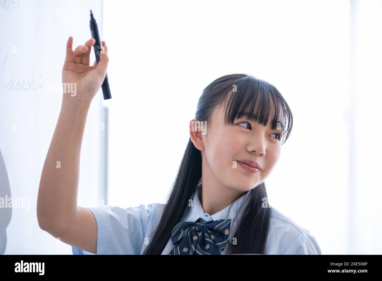 Student writing answers on whiteboard Stock Photo - Alamy