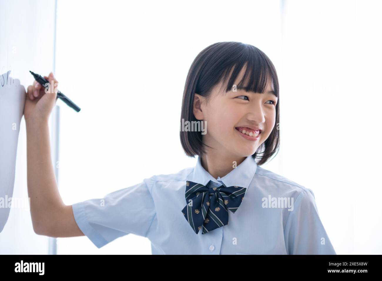 Student writing answers on whiteboard Stock Photo - Alamy