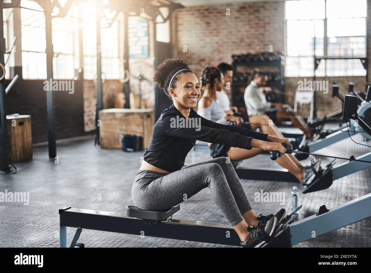 Exercise, gym and woman on rowing machine for health, wellness and body ...