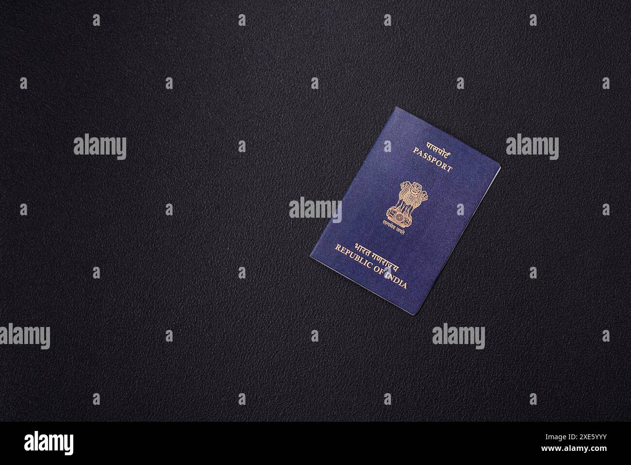 Physical paper international passport of Indian citizen on dark ...