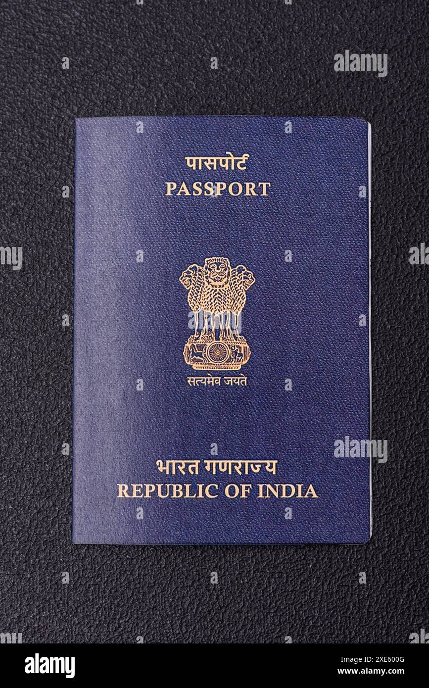 Physical paper international passport of Indian citizen on dark ...