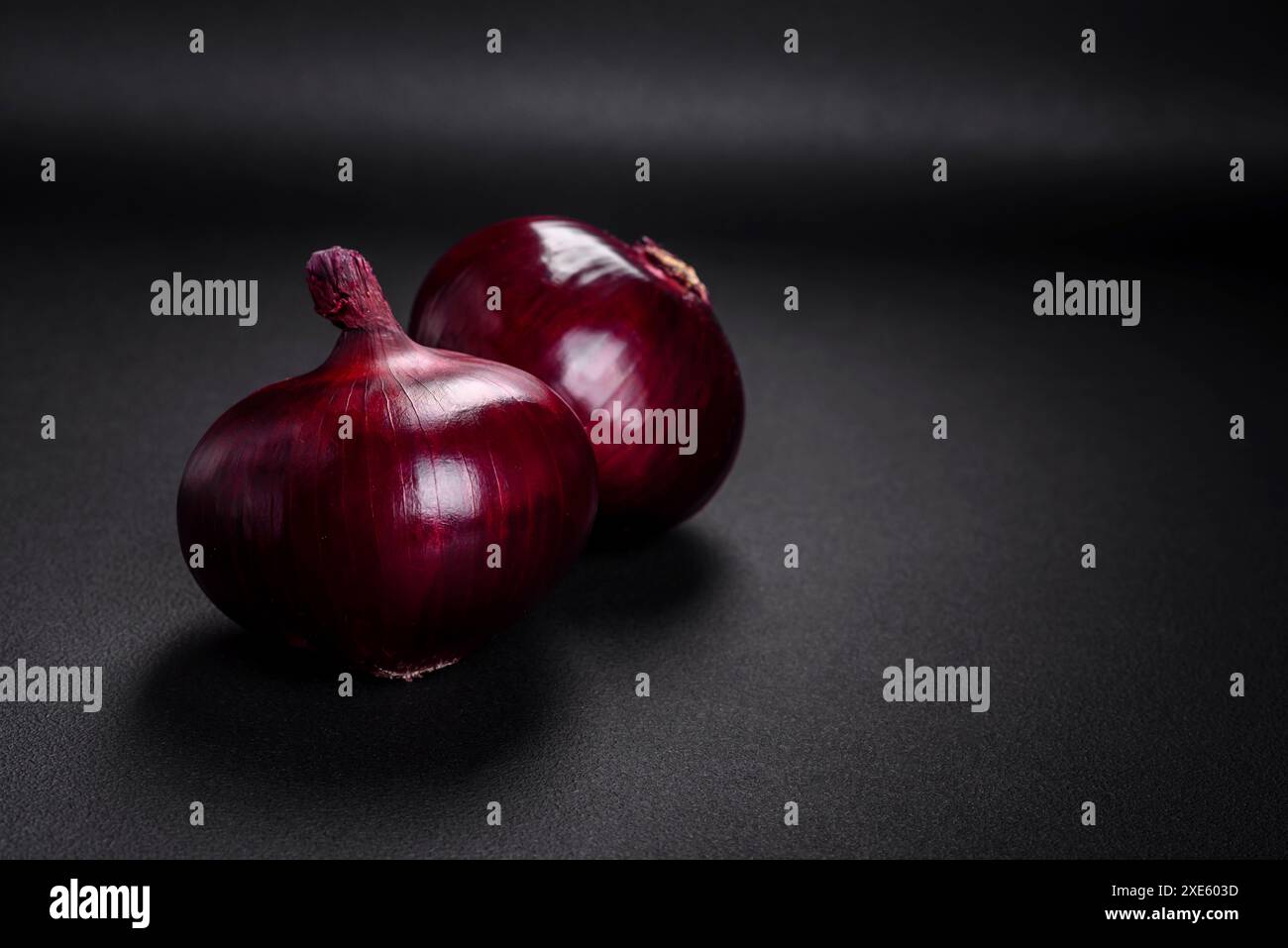 Fresh raw red onion on dark textured concrete background Stock Photo ...