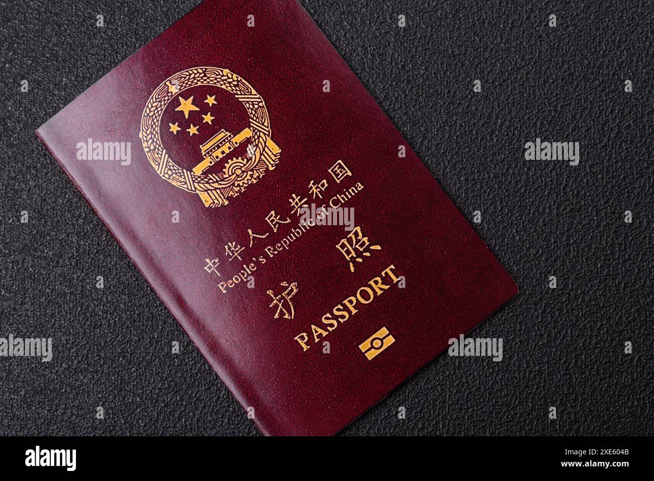 Physical paper international passport of a Chinese citizen on a dark ...
