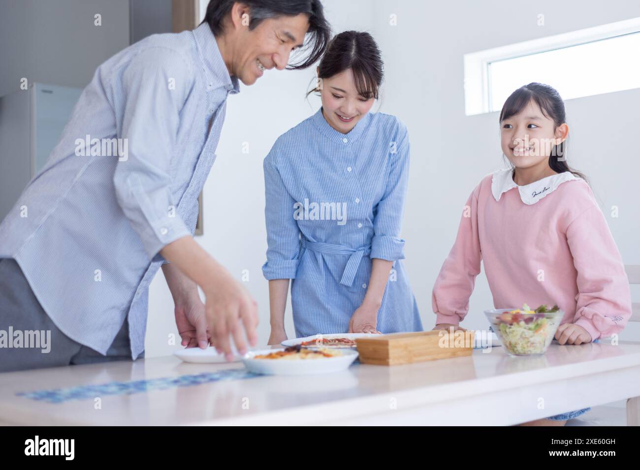 Family carrying food Stock Photo - Alamy