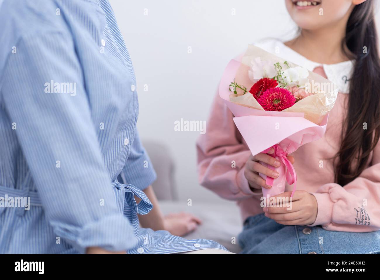 Girl presenting flowers Stock Photo - Alamy
