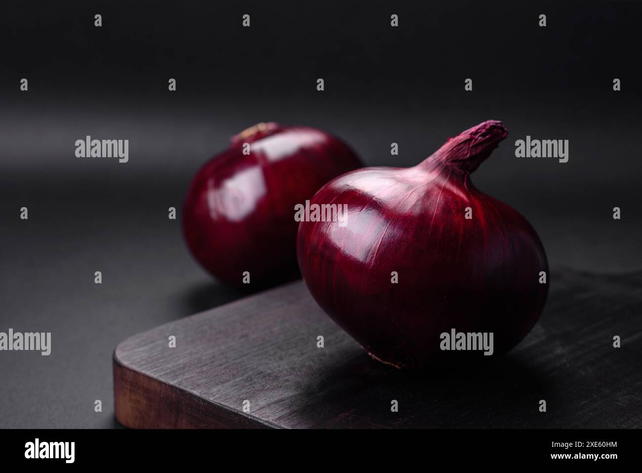 Fresh raw red onion on dark textured concrete background Stock Photo ...