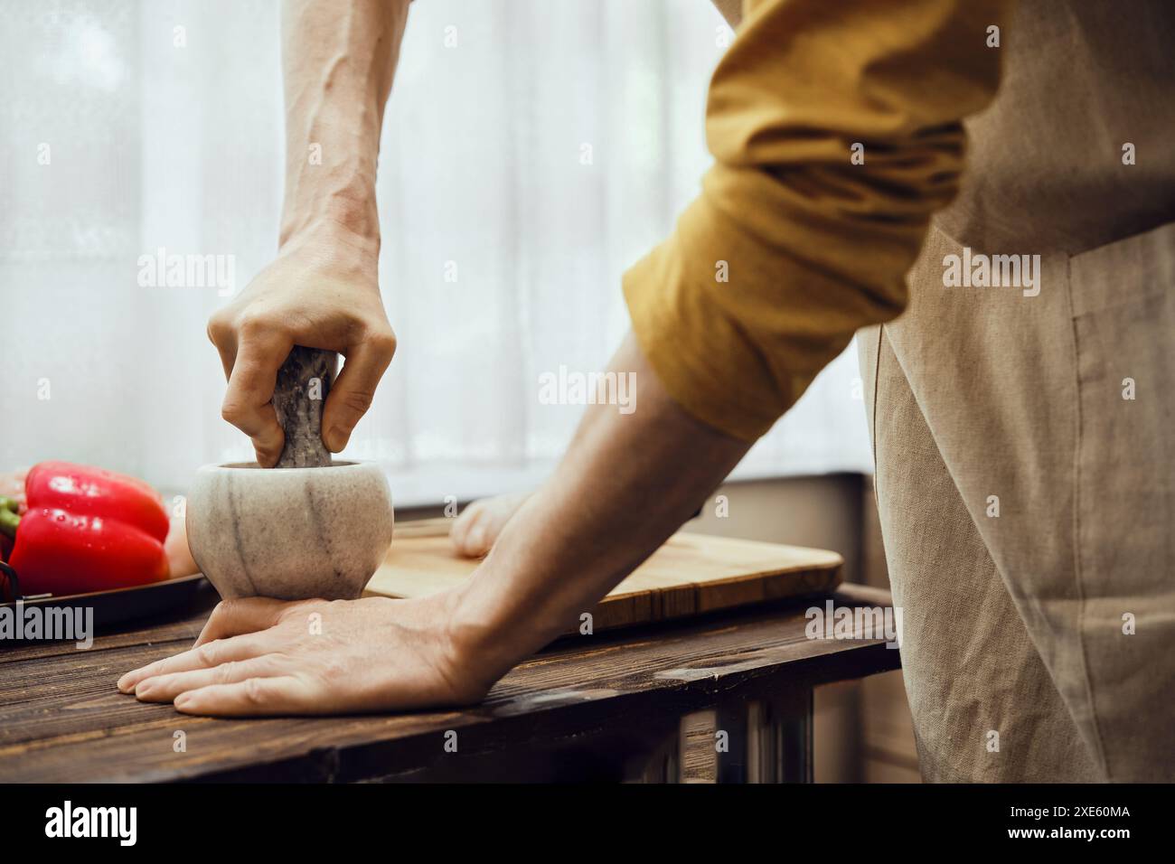 Unrecognizable man grinds pepper in a mortar using a pestle Stock Photo ...