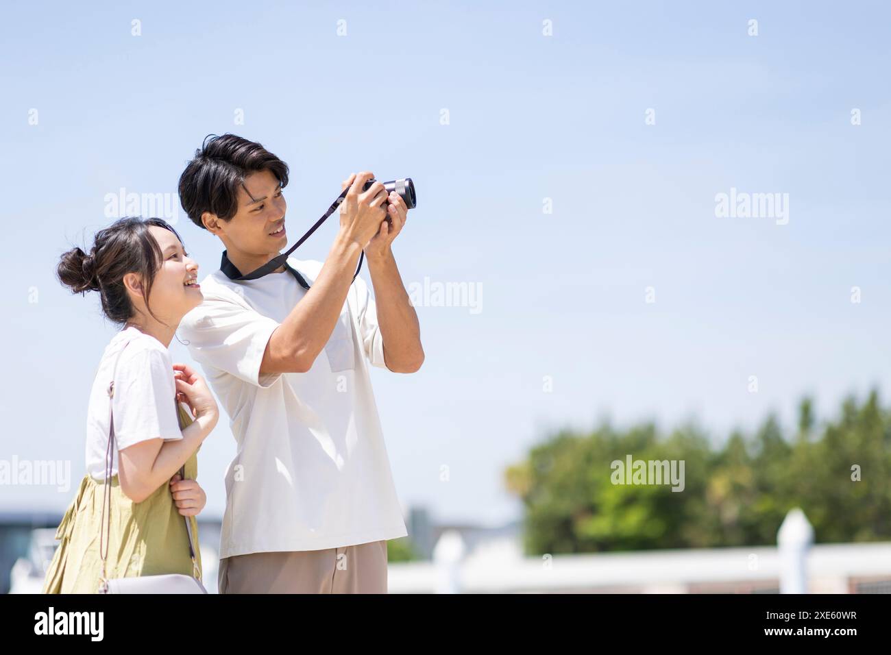 Man and woman taking a photograph Stock Photo - Alamy