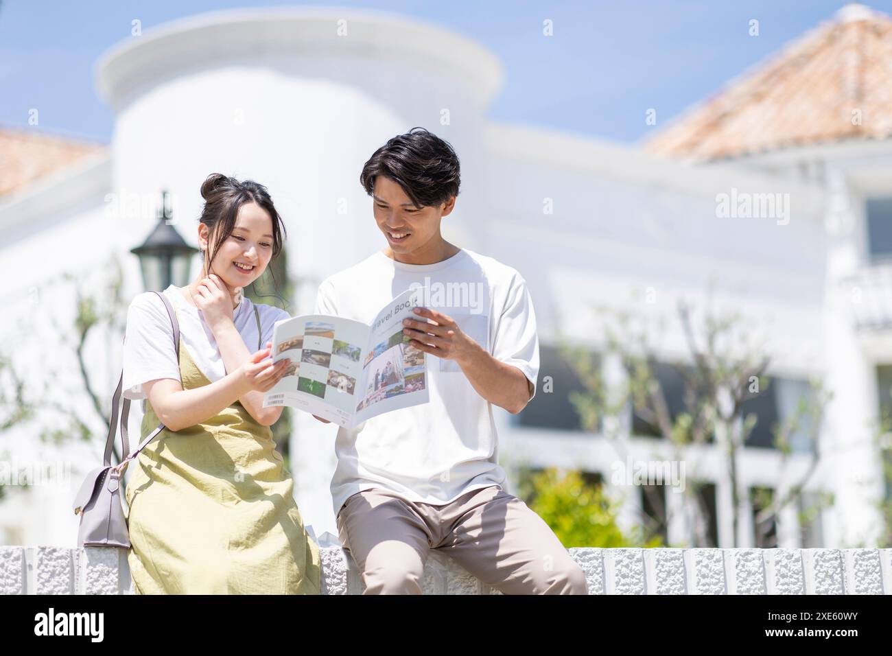 Man and woman reading guidebook Stock Photo - Alamy