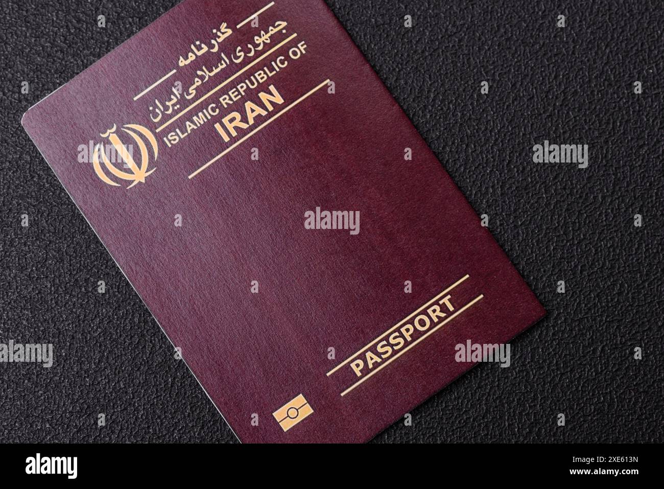 Physical paper international passport of Iranian citizen on dark ...