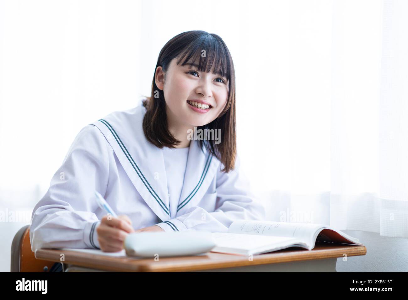 Student attending class with a smile Stock Photo - Alamy