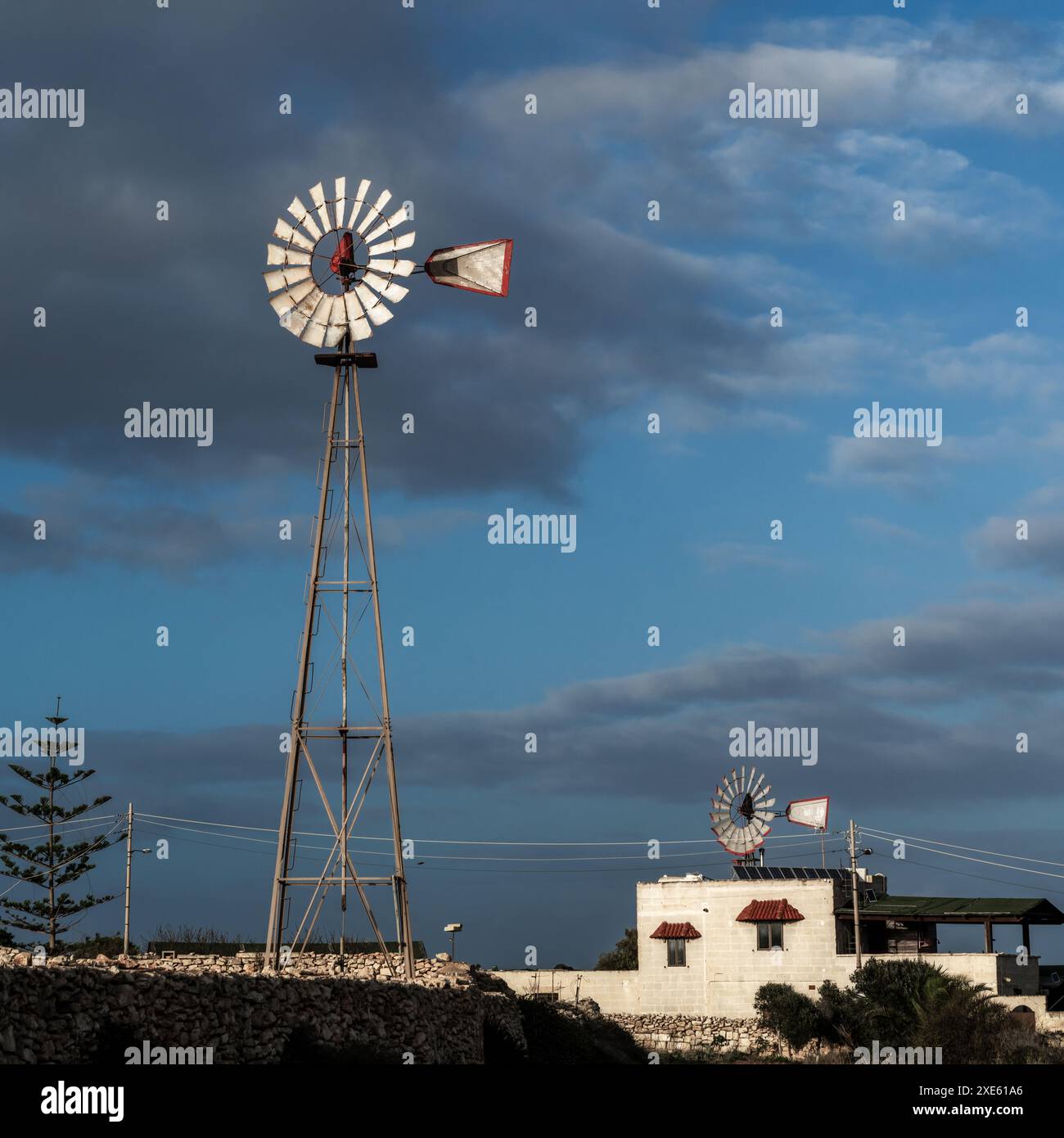 Typical cottage and wind wheels in the countryside of Malta in warm ...