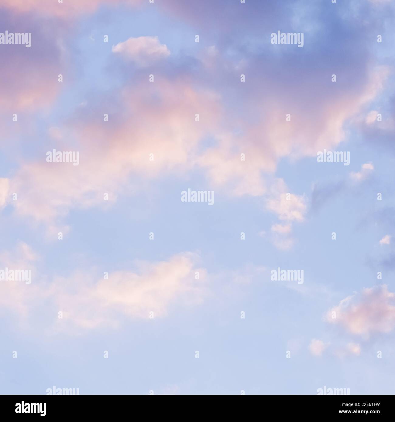 Blue sky background with pale pink clouds at sunset Stock Photo - Alamy