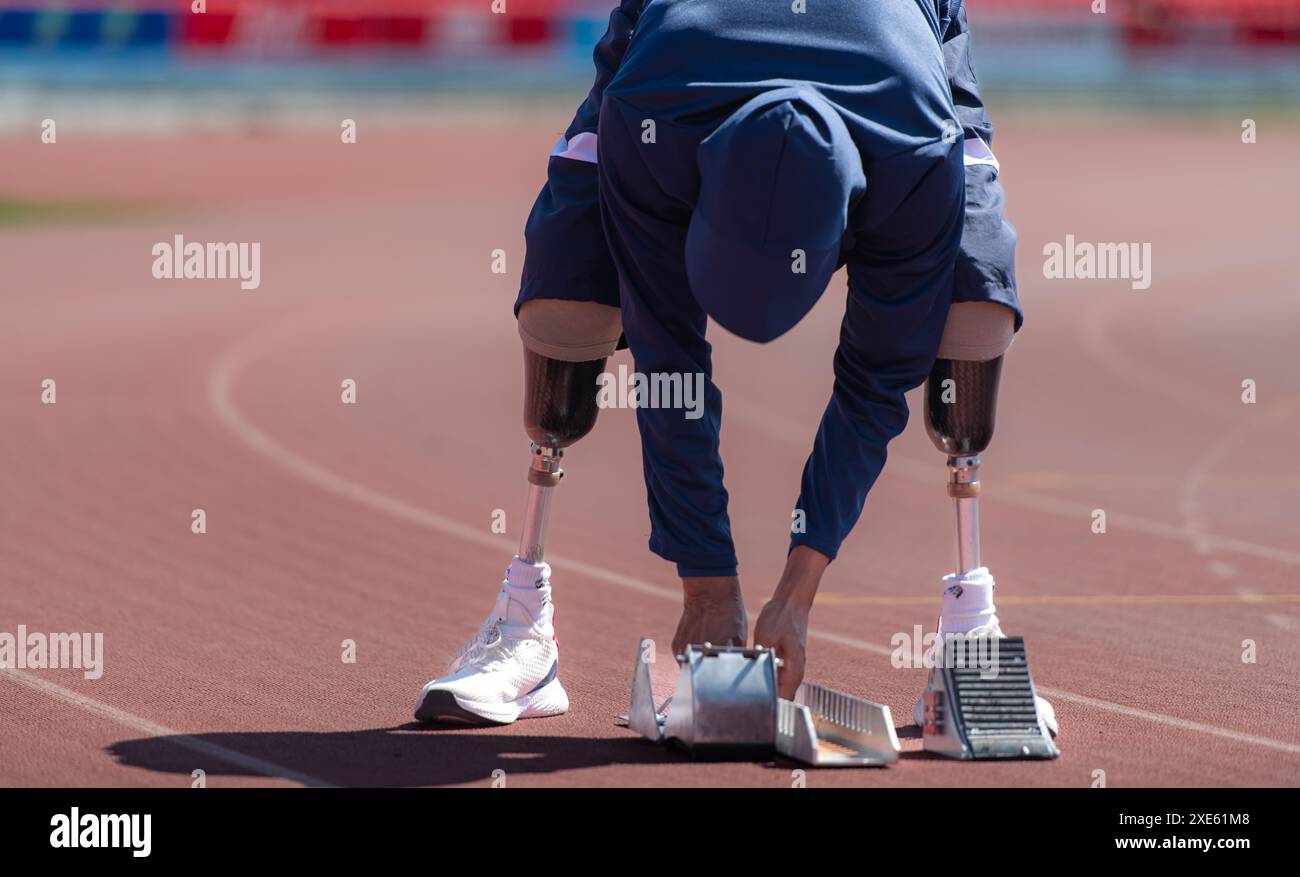 Disabled athletes prepare in starting position ready to run on stadium ...
