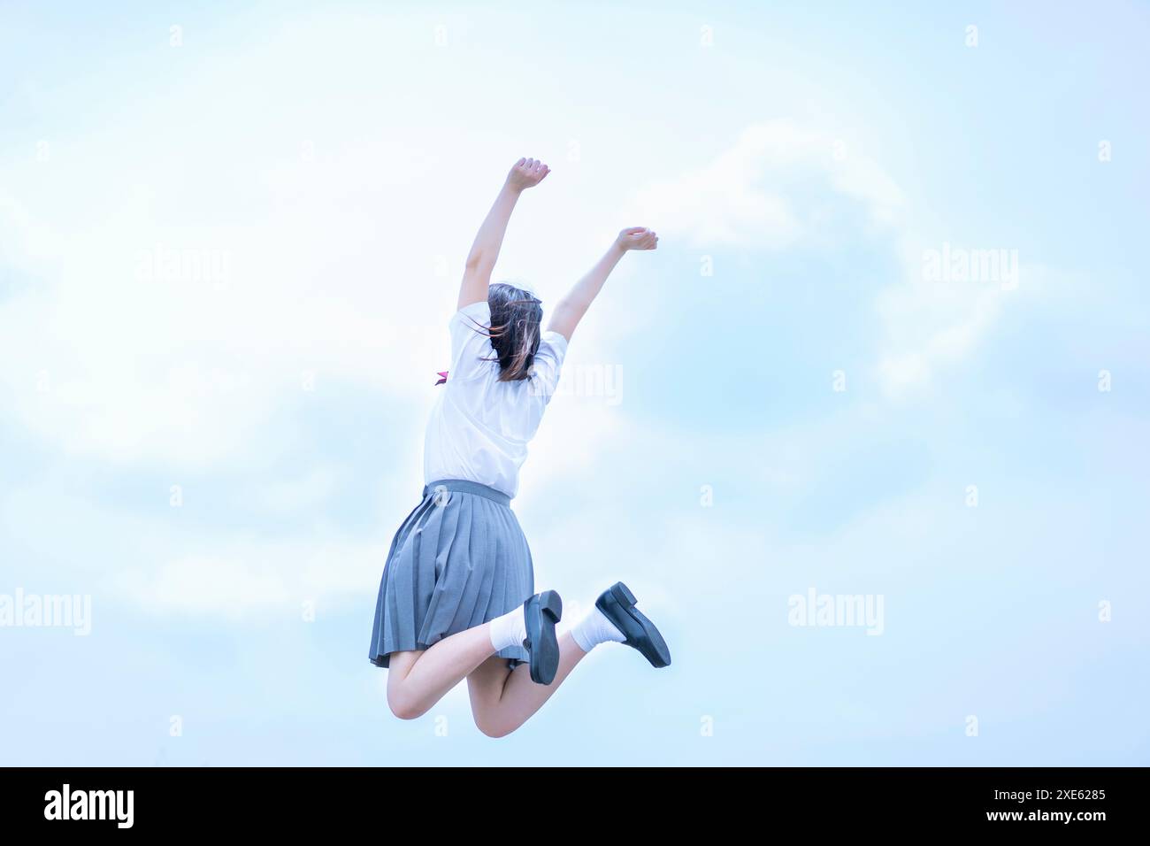Back view of jumping high school girls Stock Photo - Alamy