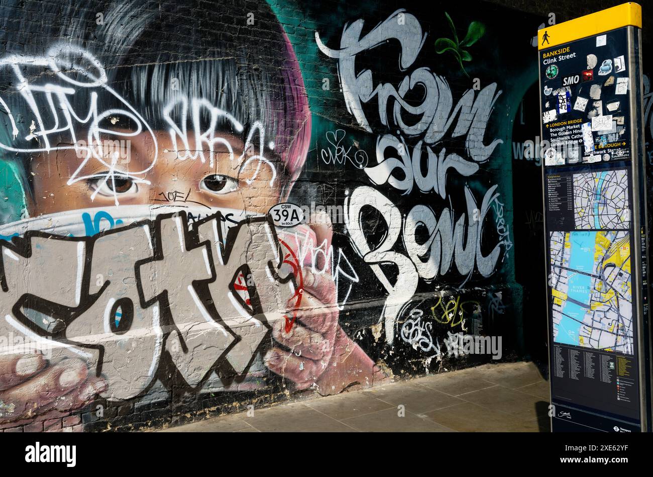 Graffiti defacing street art and a tourist map, Clink Street, London ...