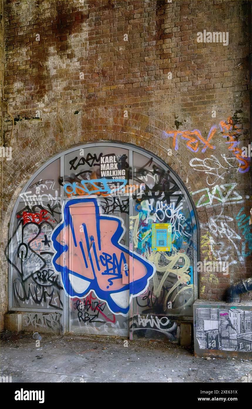 Graffiti on door on old railways arches close ot Waterloo Station ...