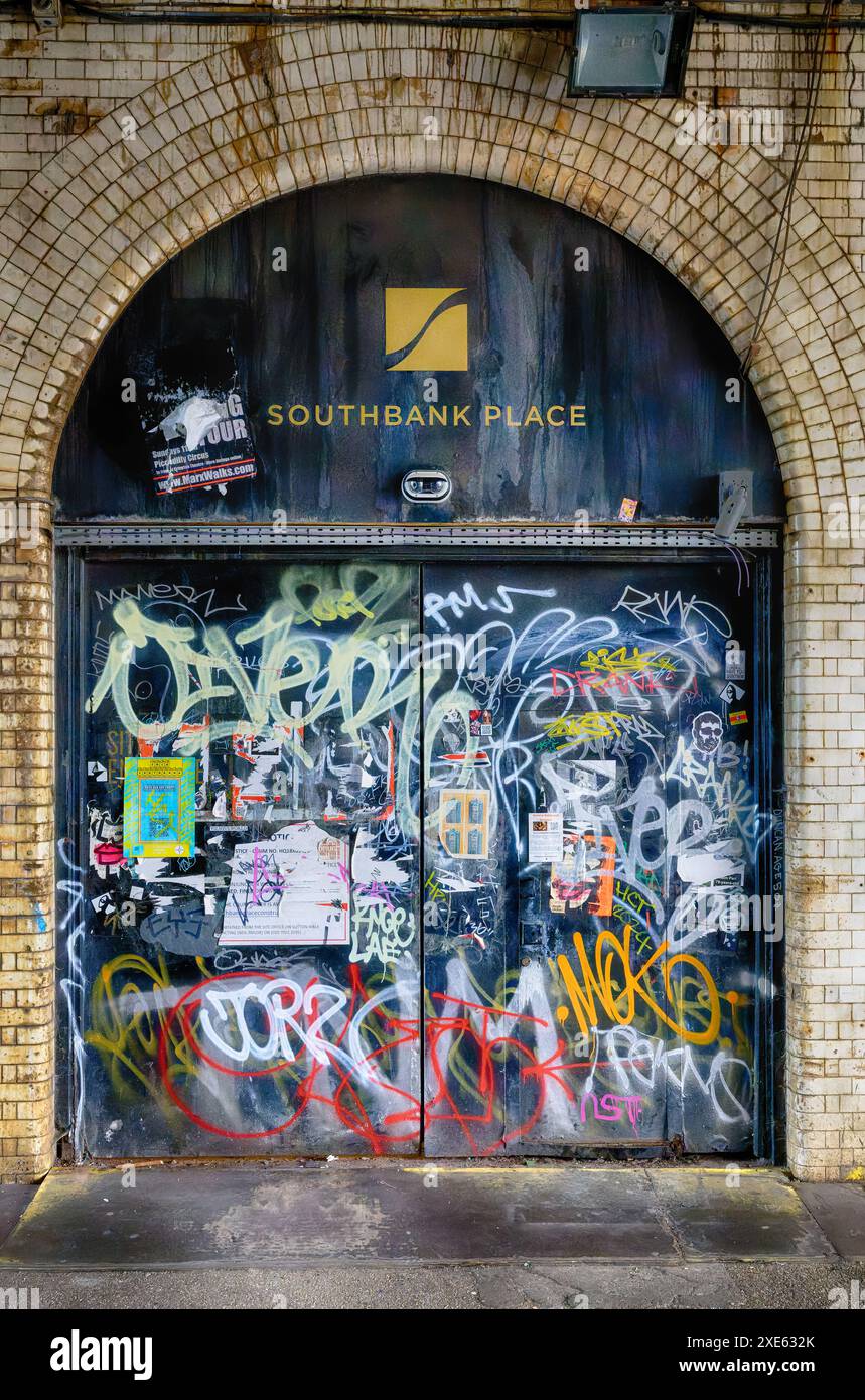 Graffiti on door on old railways arches close ot Waterloo Station ...