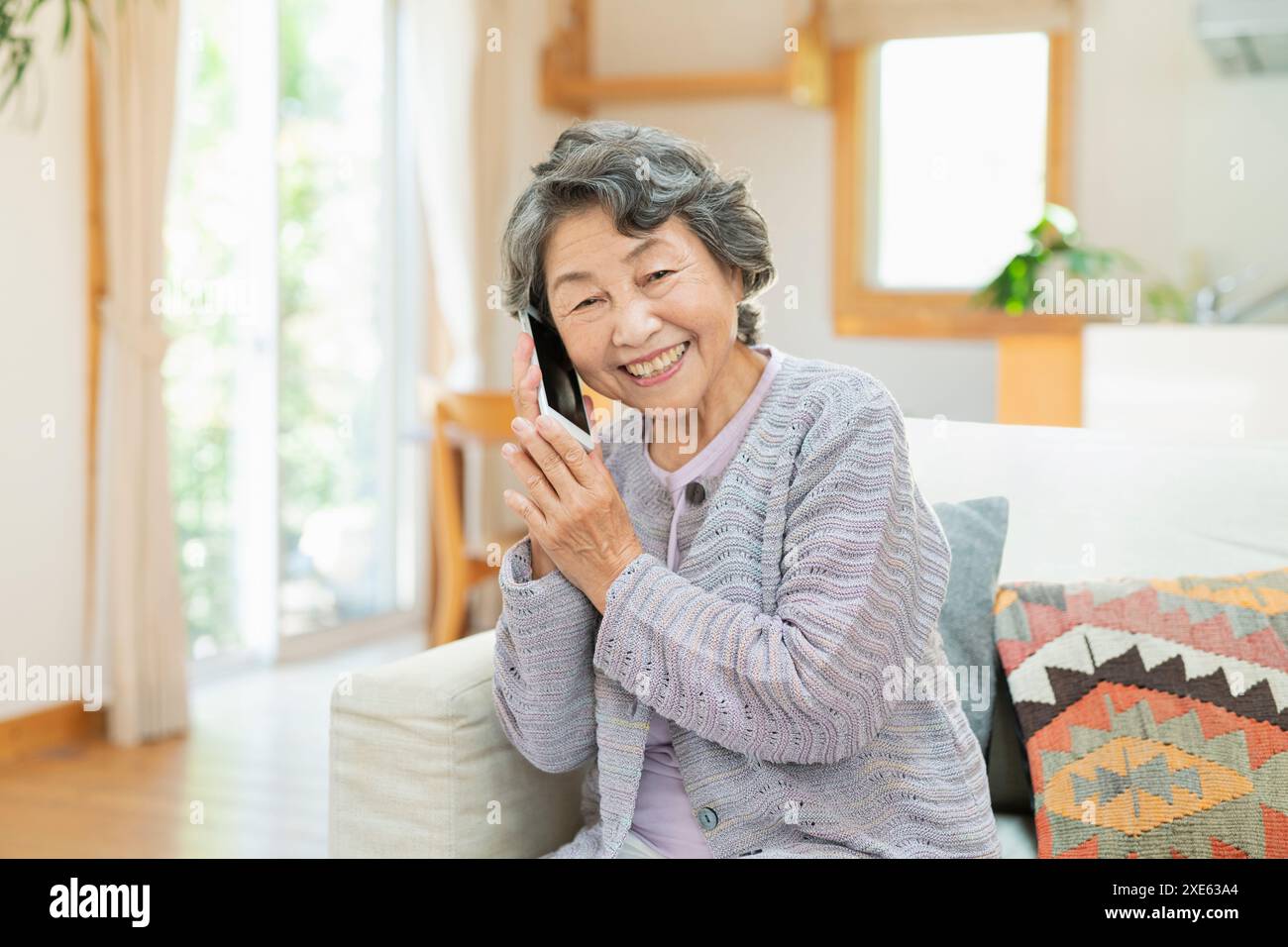 Senior woman making a phone call at home Stock Photo - Alamy