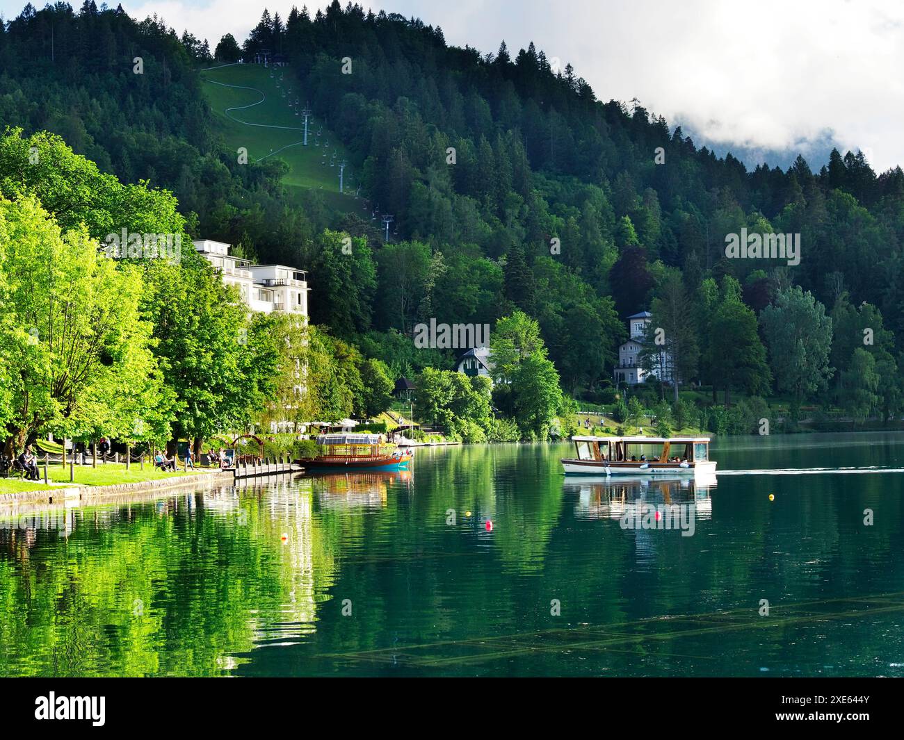 Electric boat arriving at Bled Village from Bled Island on Lake Bled ...
